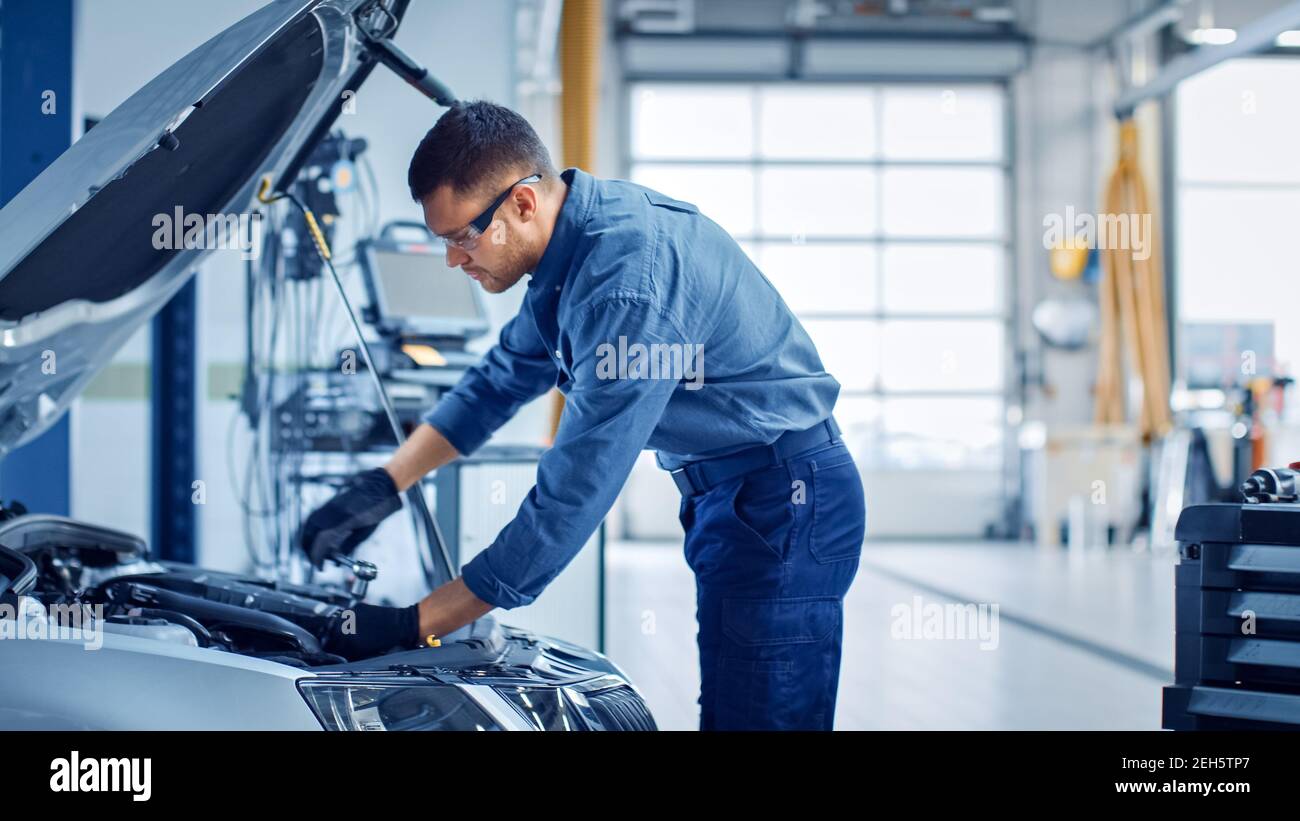 Professional Mechanic is Working on a Car in a Car Service. Repairman ...