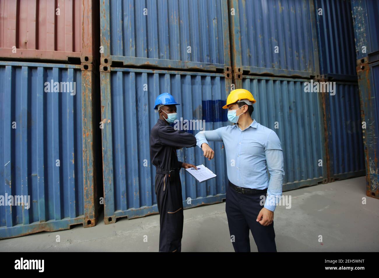 Engineer or supervisor checking and control loading Containers box from Cargo at harbor.Foreman ...