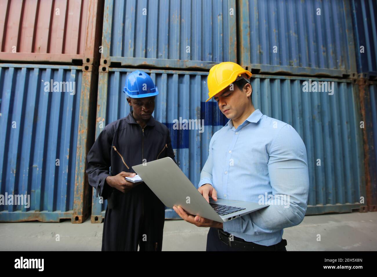Engineer or supervisor checking and control loading Containers box from ...
