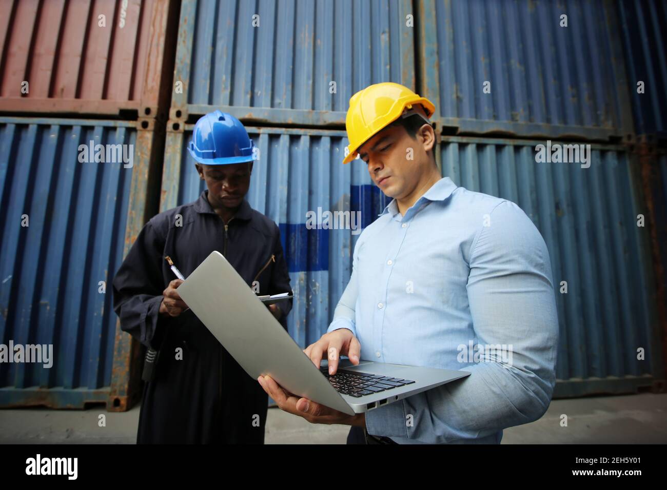 Engineer or supervisor checking and control loading Containers box from ...