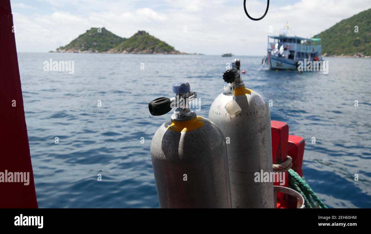 Row of oxygen tanks and diving equipment placed on modern boat in ...