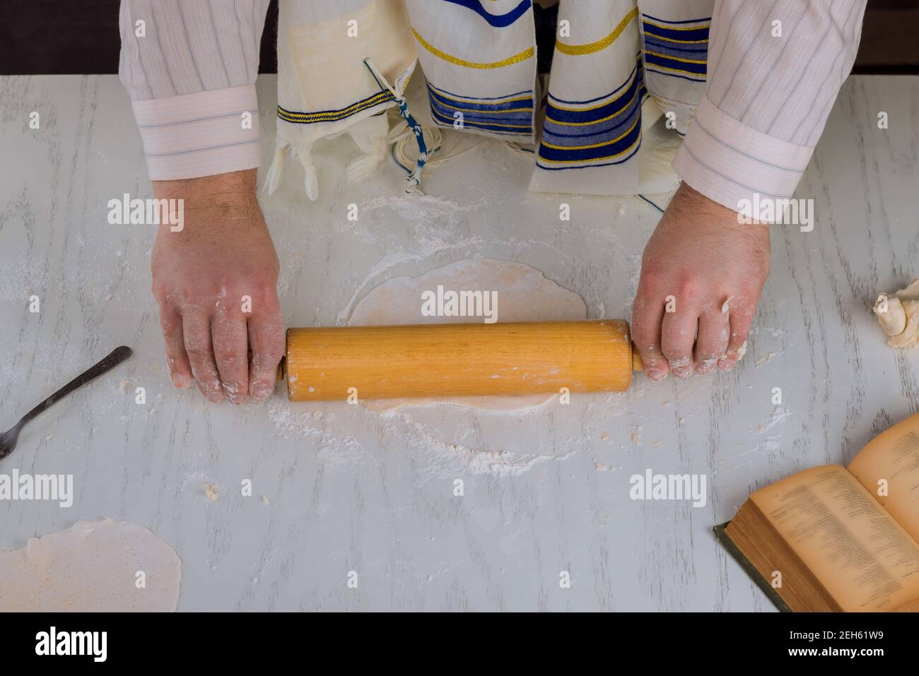 Orthodox Jewish man prepare hand made flat kosher matzah for baking ...