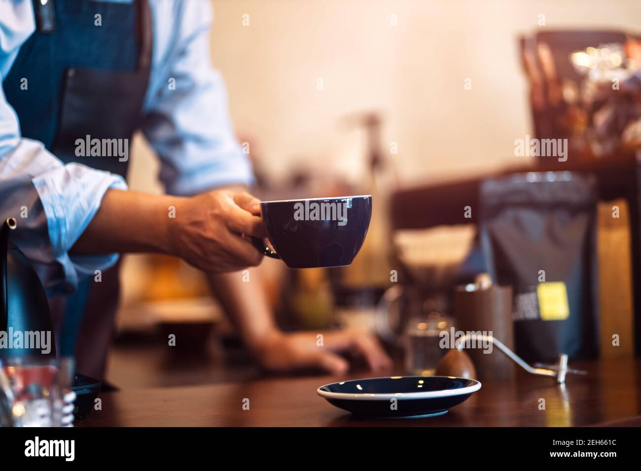 barista pouring boiling water from kettle to drip coffee maker Stock ...