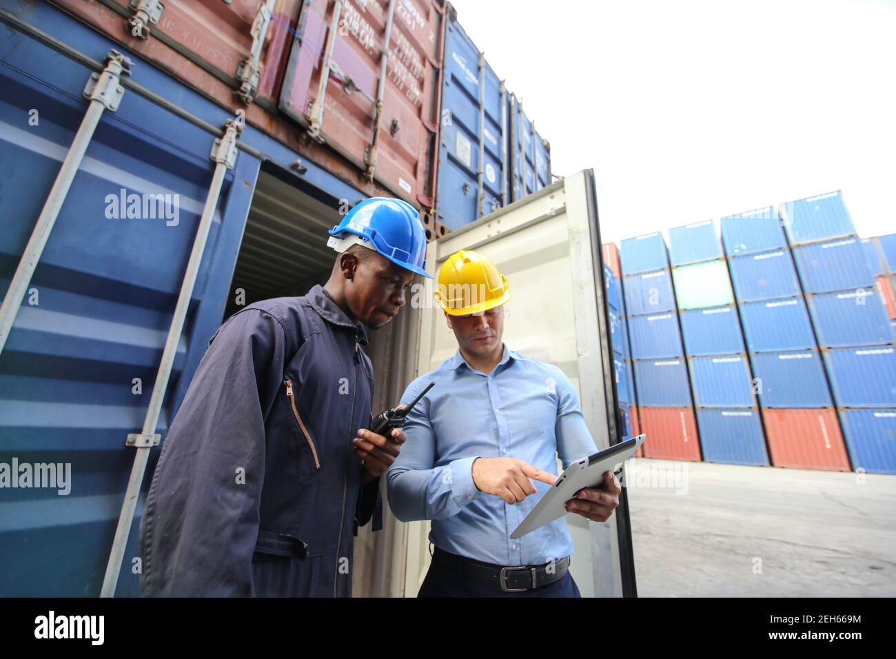 Engineer or supervisor checking and control loading Containers box from ...