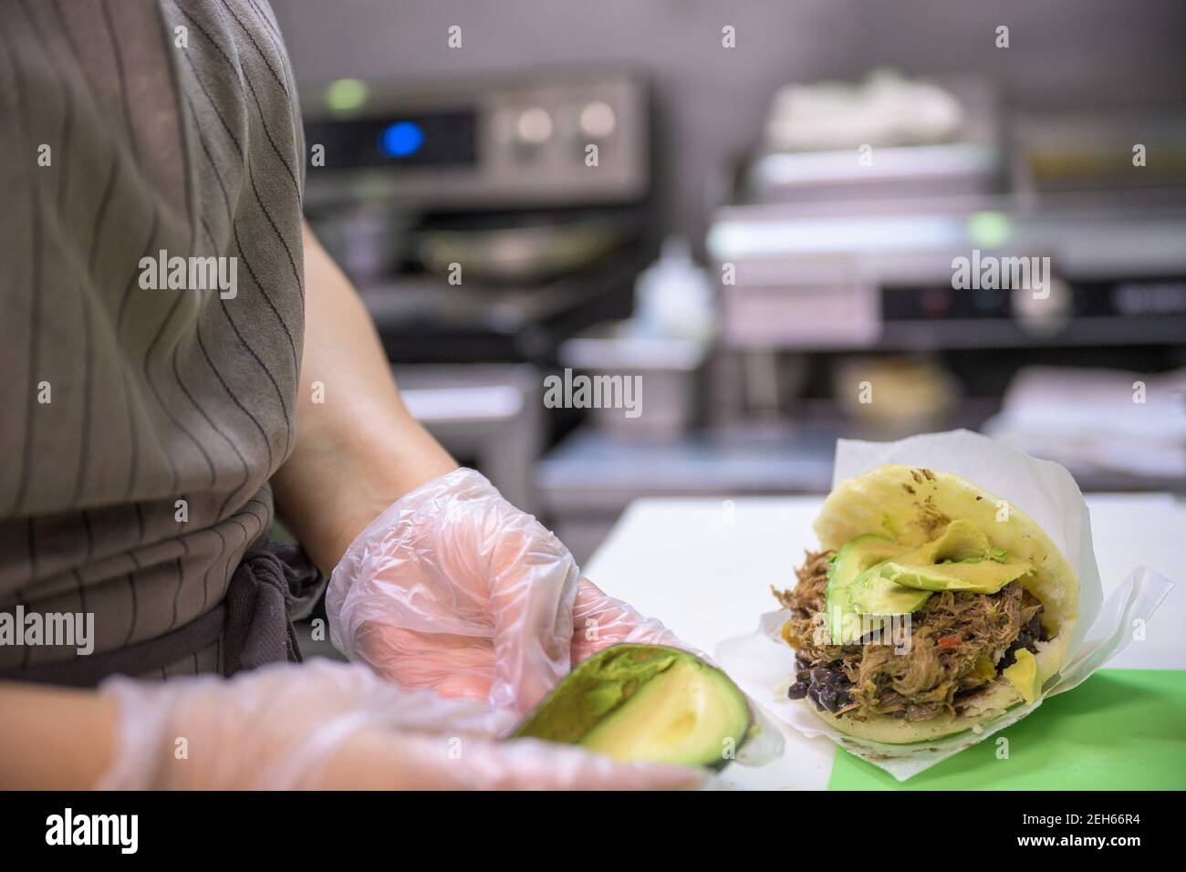 Chef making a delicious Arepa with chicken and avocado, Venezuelan ...