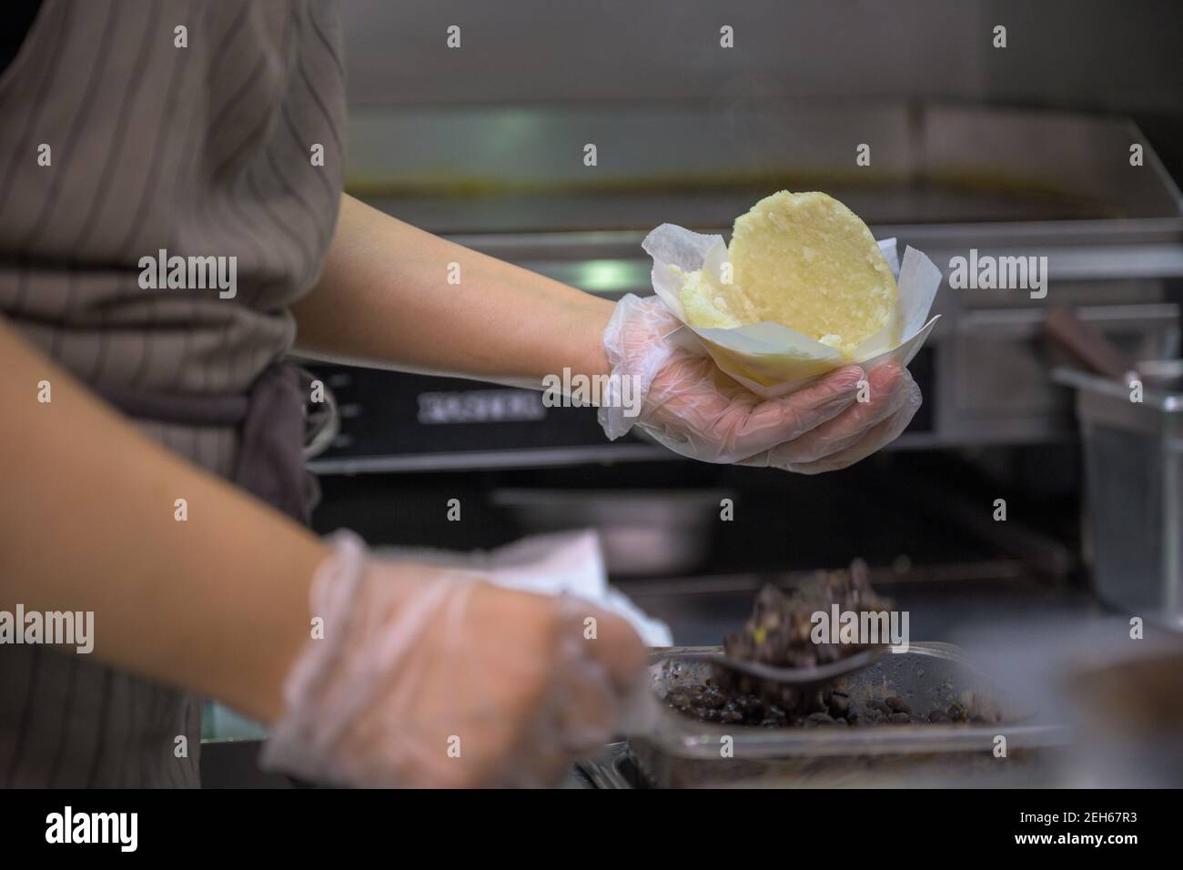 Closeup shot of the process of making sweet Arepa, Venezuelan ...
