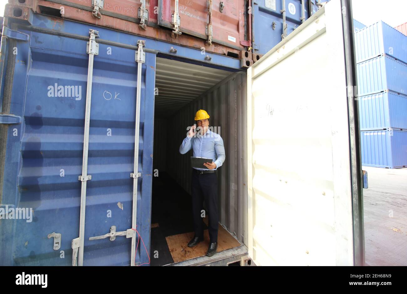 Engineer or supervisor checking and control loading Containers box from ...