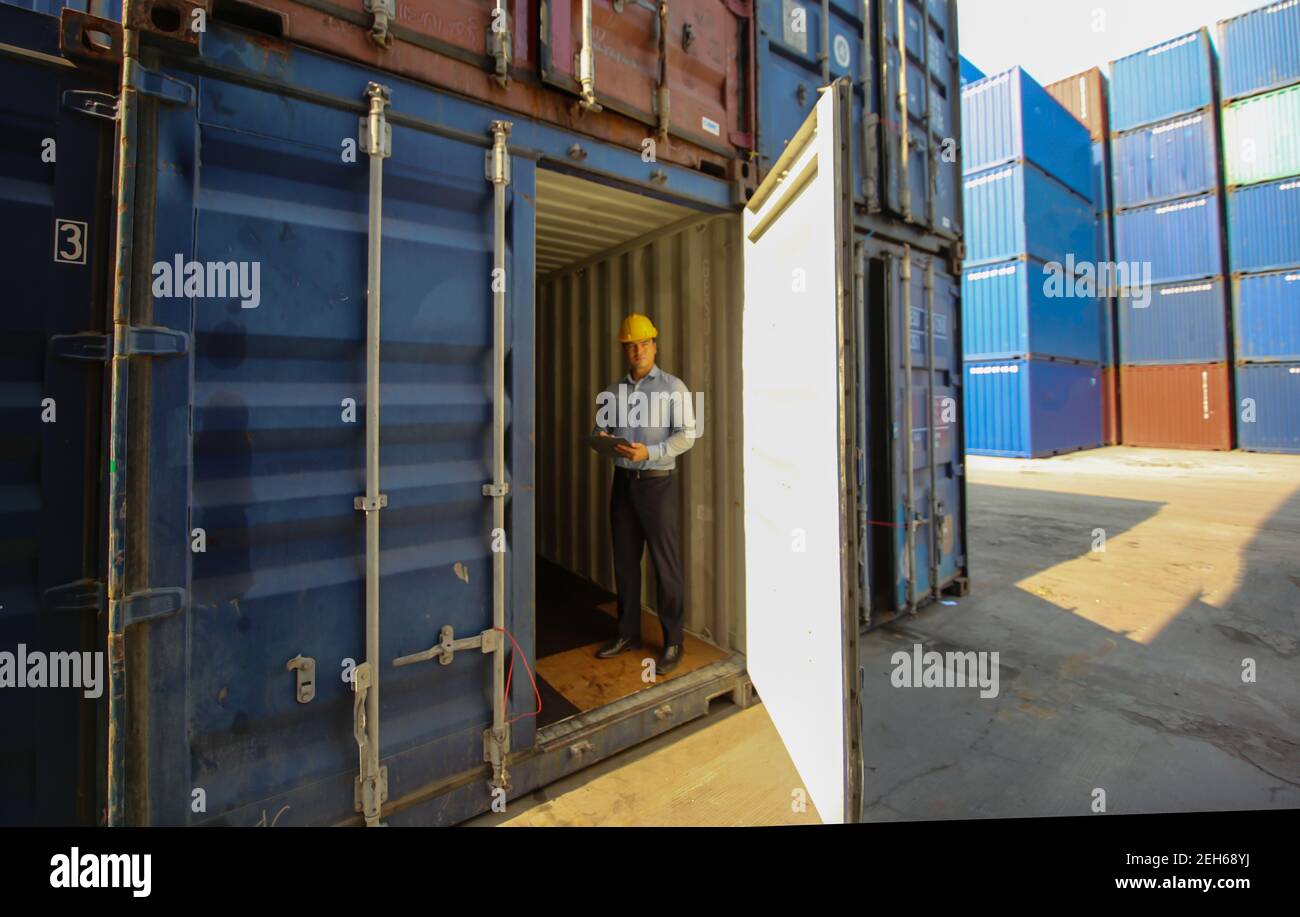 Engineer or supervisor checking and control loading Containers box from ...