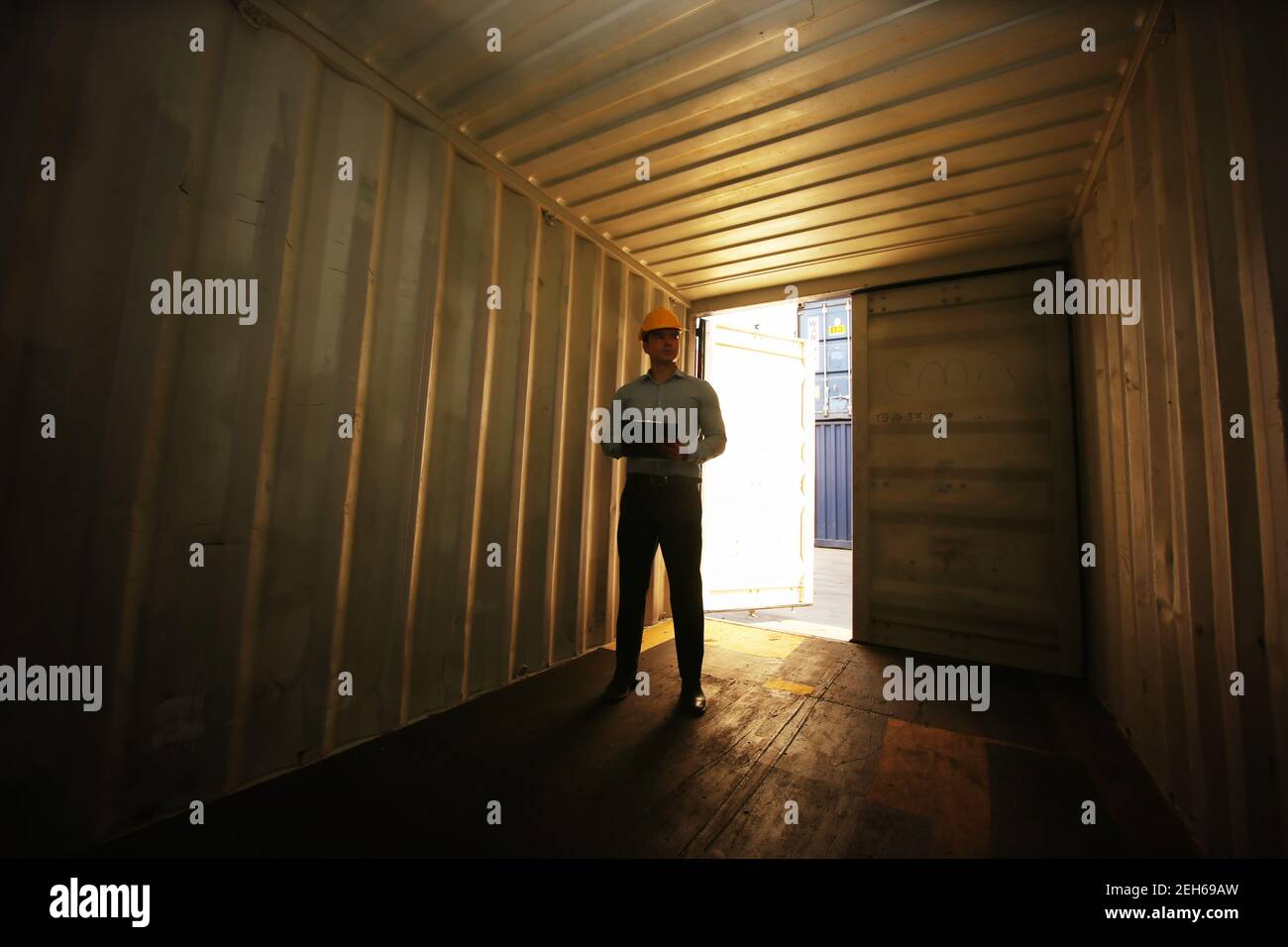 Engineer or supervisor checking and control loading Containers box from ...