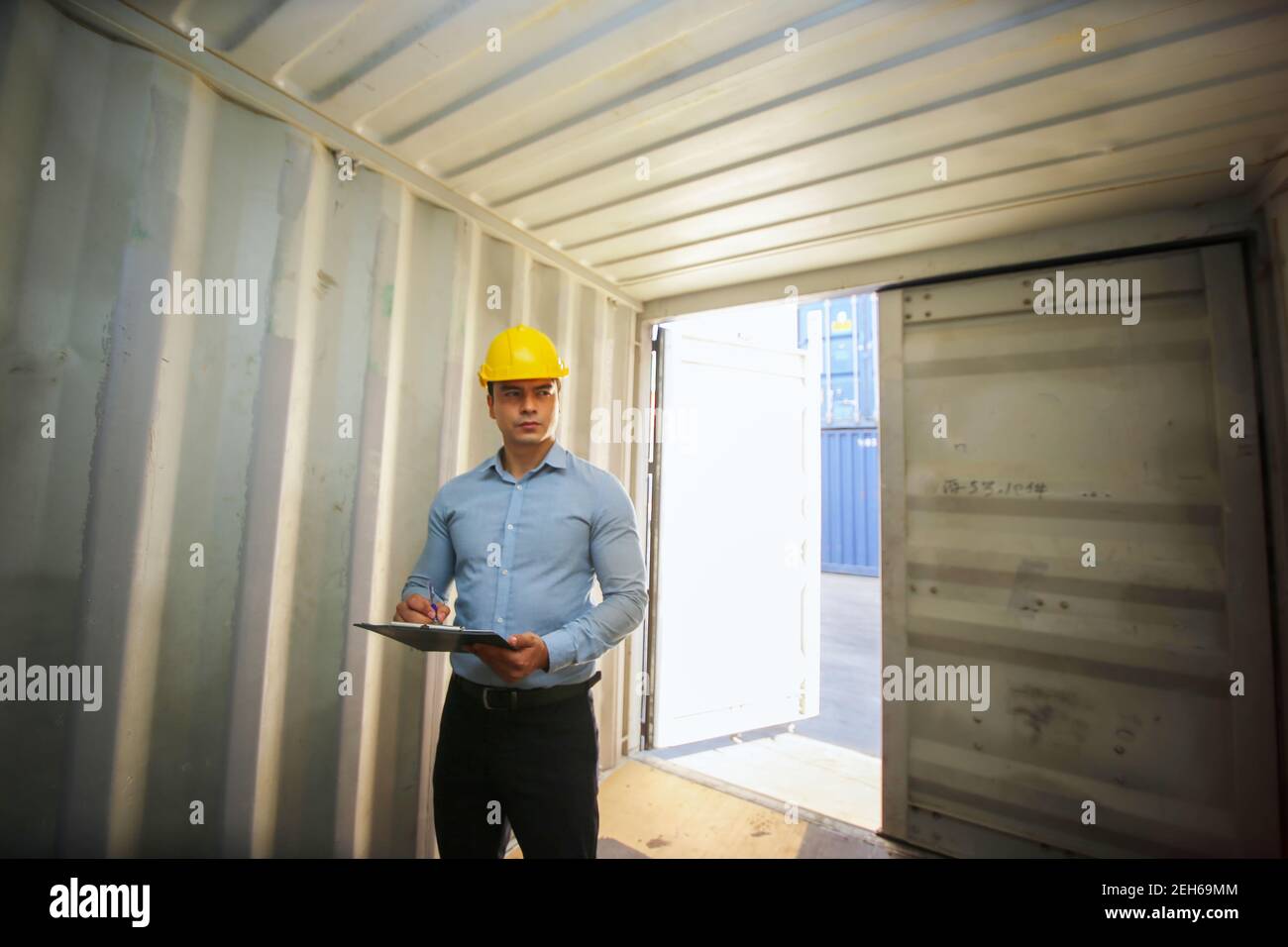 Engineer or supervisor checking and control loading Containers box from ...