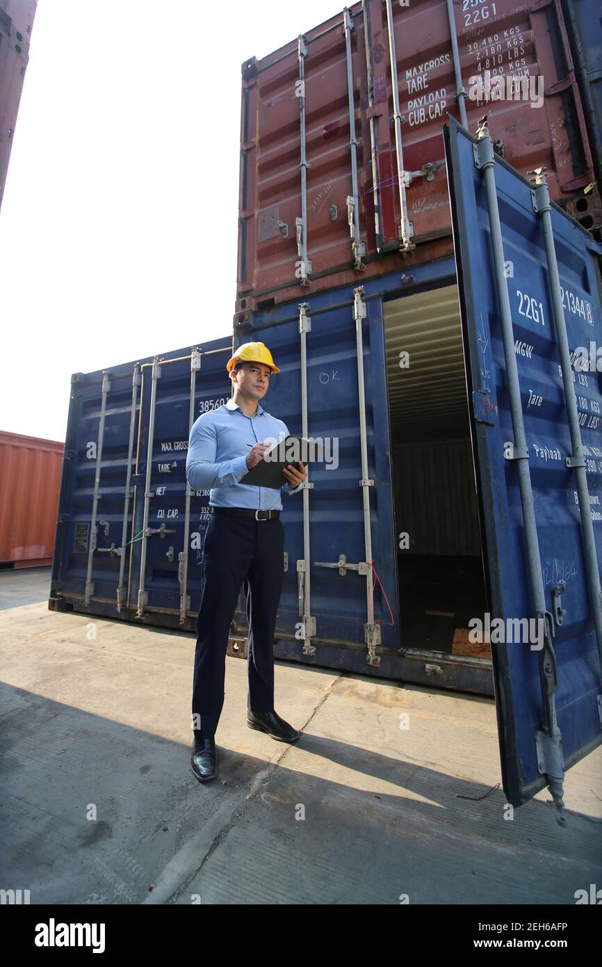 Engineer or supervisor checking and control loading Containers box from ...
