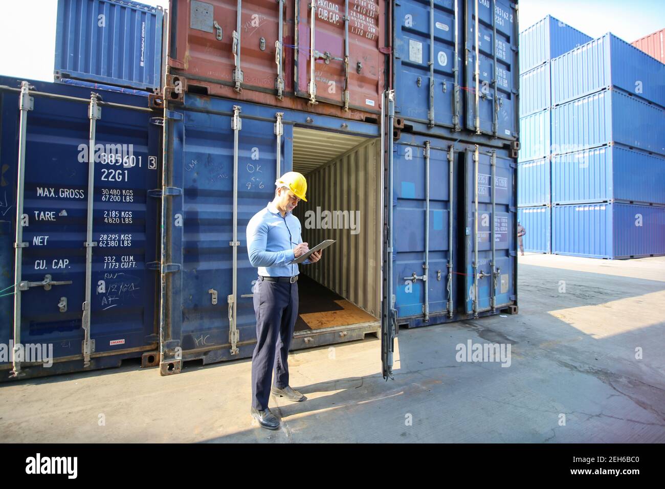 Engineer or supervisor checking and control loading Containers box from ...