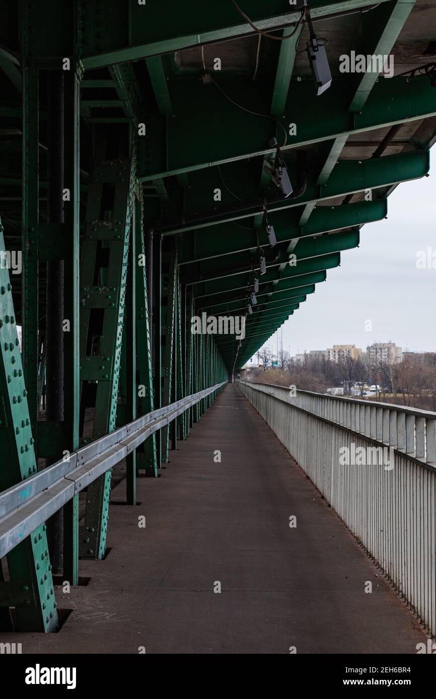 Long wooden and metal bridge with tram rails and green construction ...