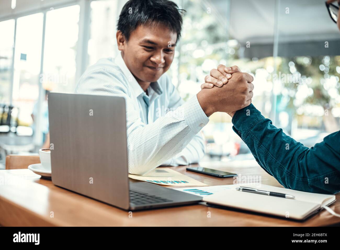 Two Business people Competing In Arm Wrestling Stock Photo - Alamy