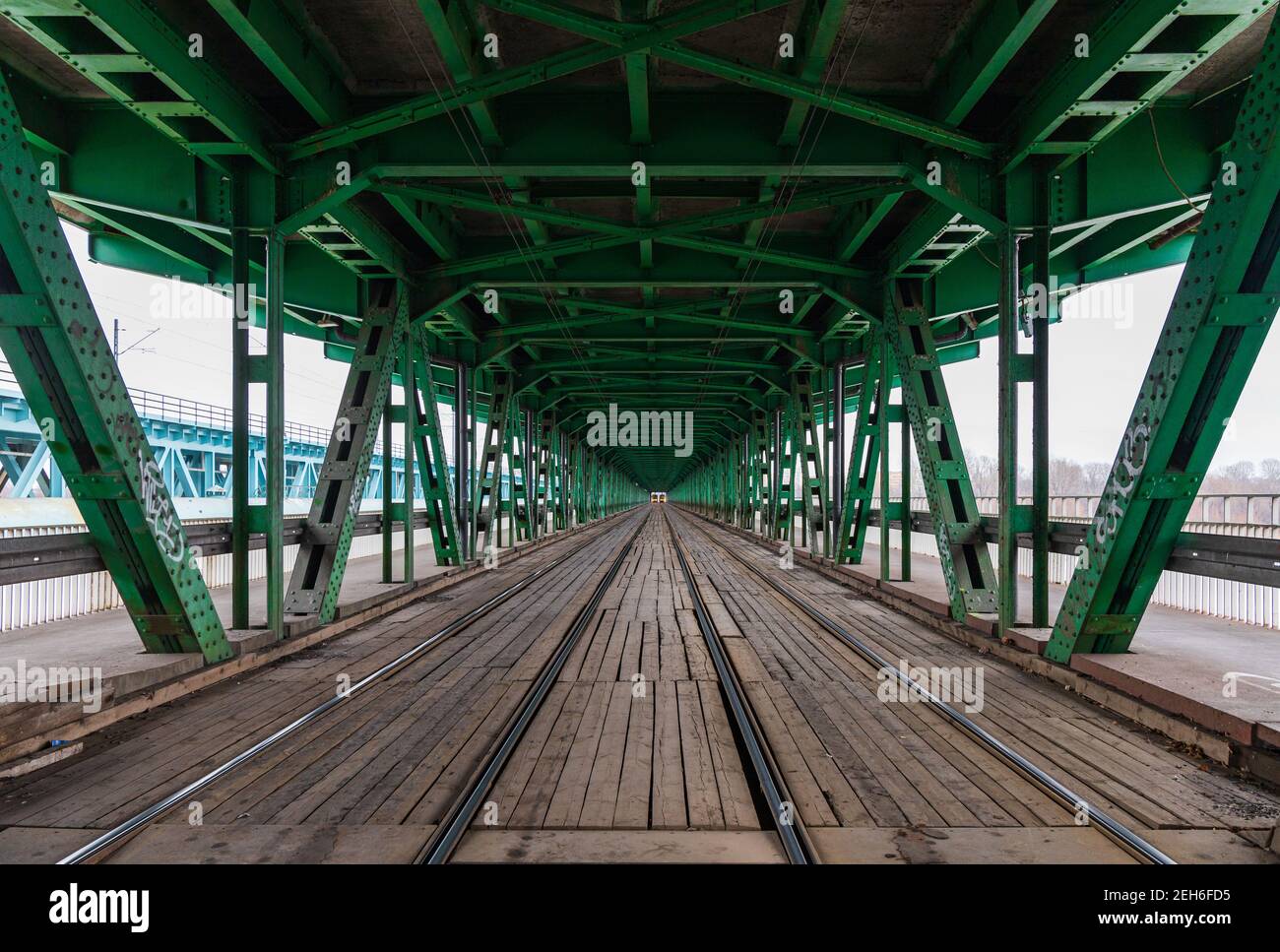 Long wooden and metal bridge with tram rails and green roof Stock Photo ...