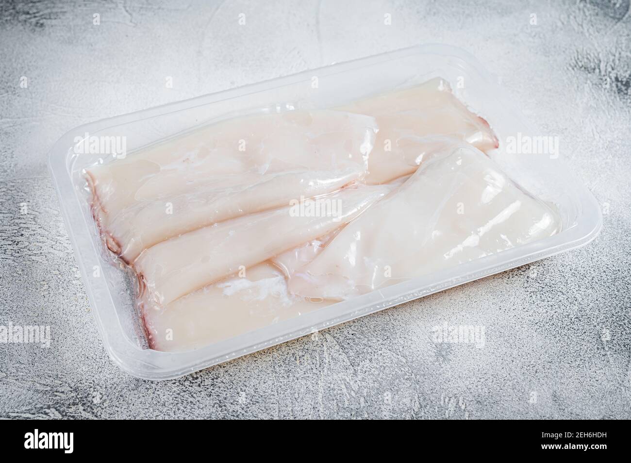 Raw squid or Calamari in a vacuum package from the supermarket. White ...