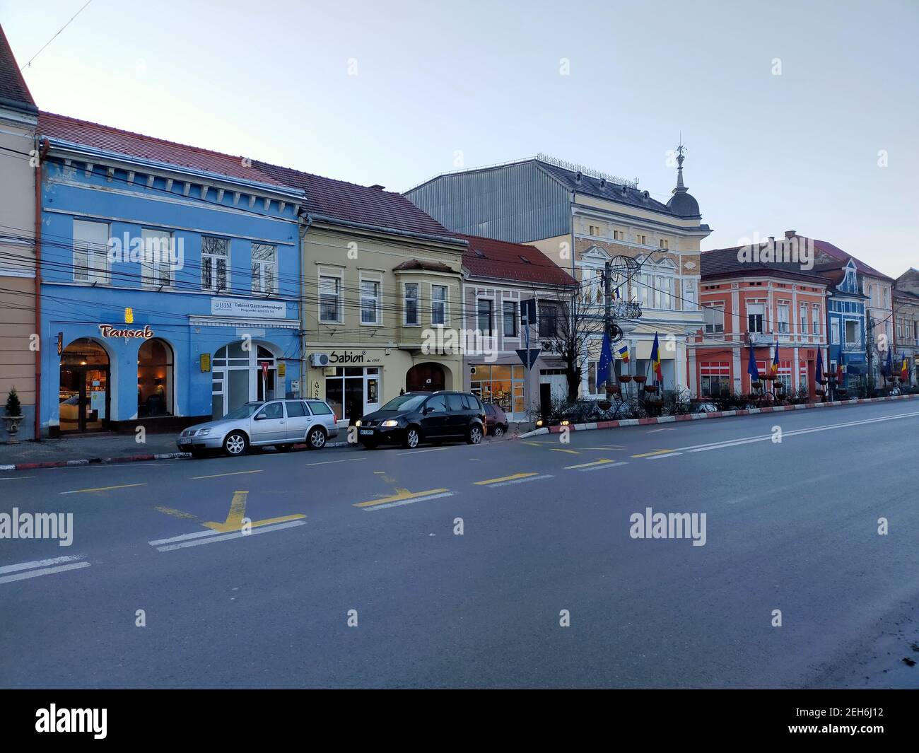 REGHIN, ROMANIA - Feb 09, 2021: Empty road in a city with buildings ...