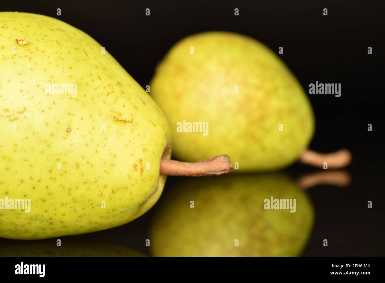 Two whole ripe juicy tasty Lucas pears on a black background Stock ...