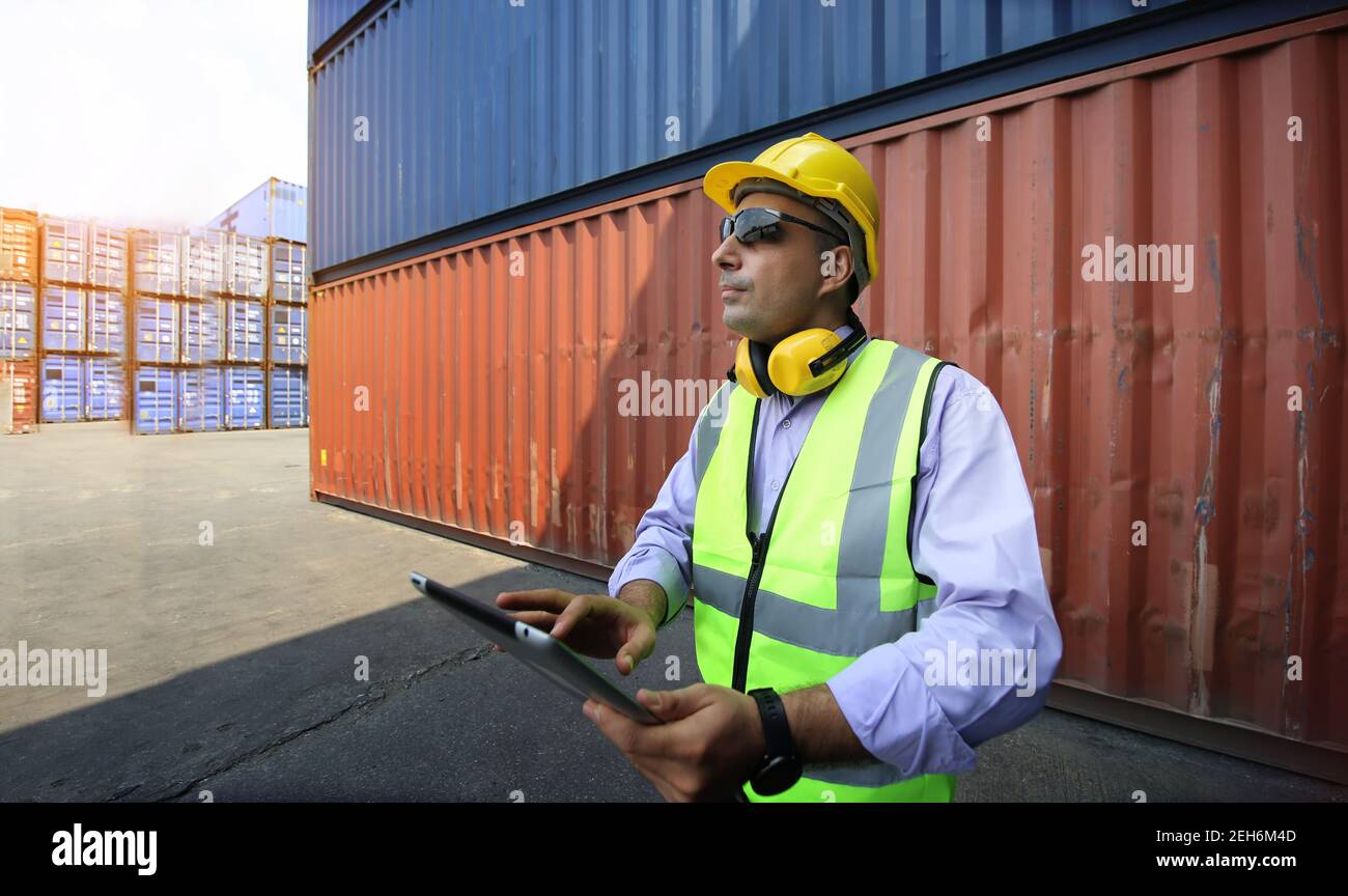 Foreman control loading Containers box from Cargo freight ship for ...