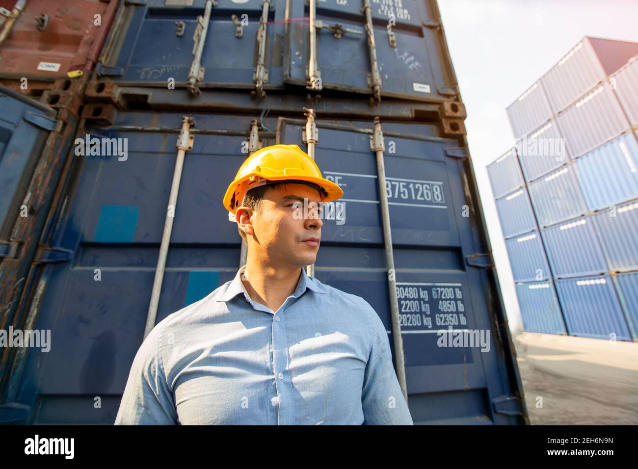 Foreman control loading Containers box from Cargo freight ship for ...