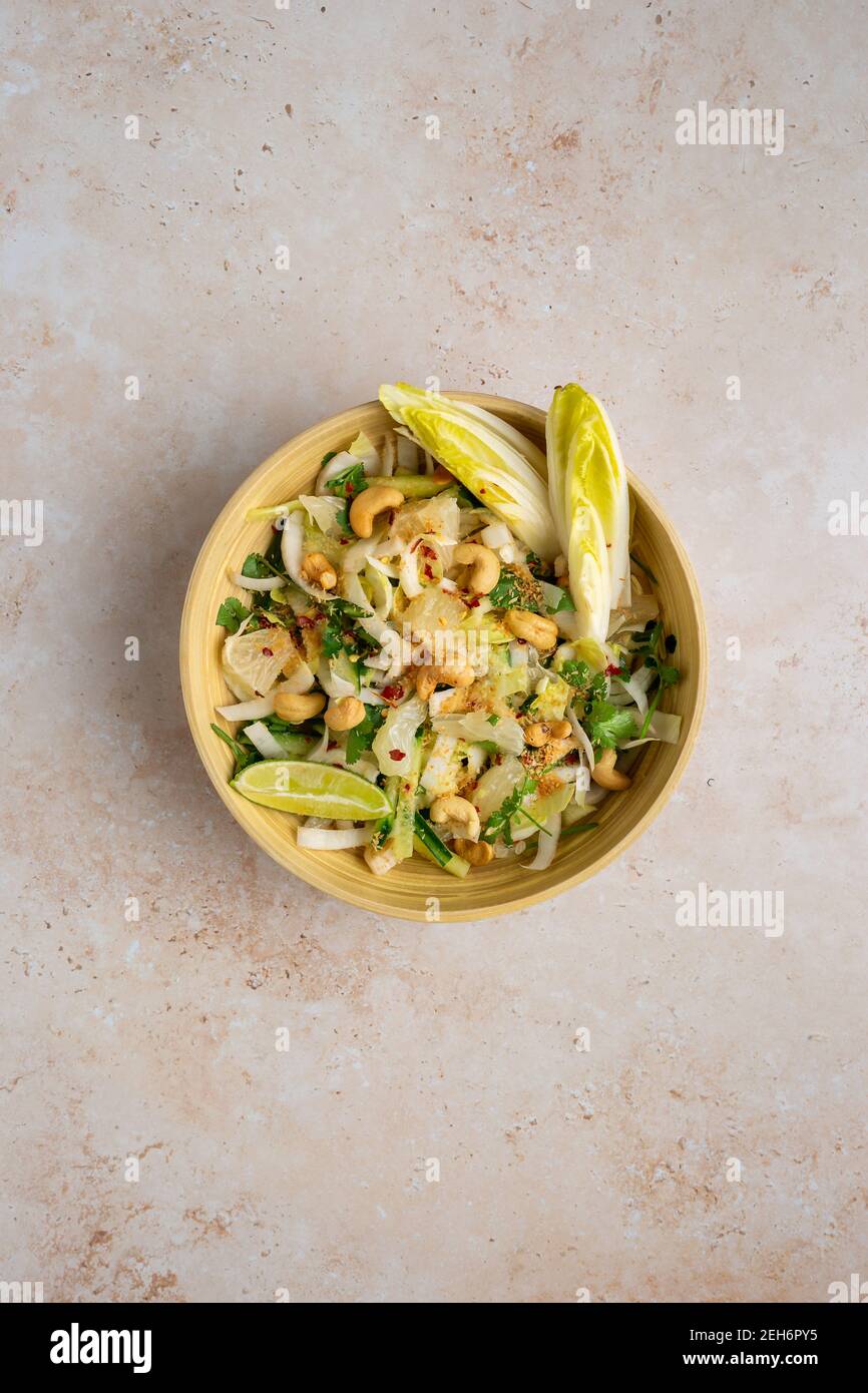 Top down view of a delicious vegan Bali style pomelo salad with chicory ...