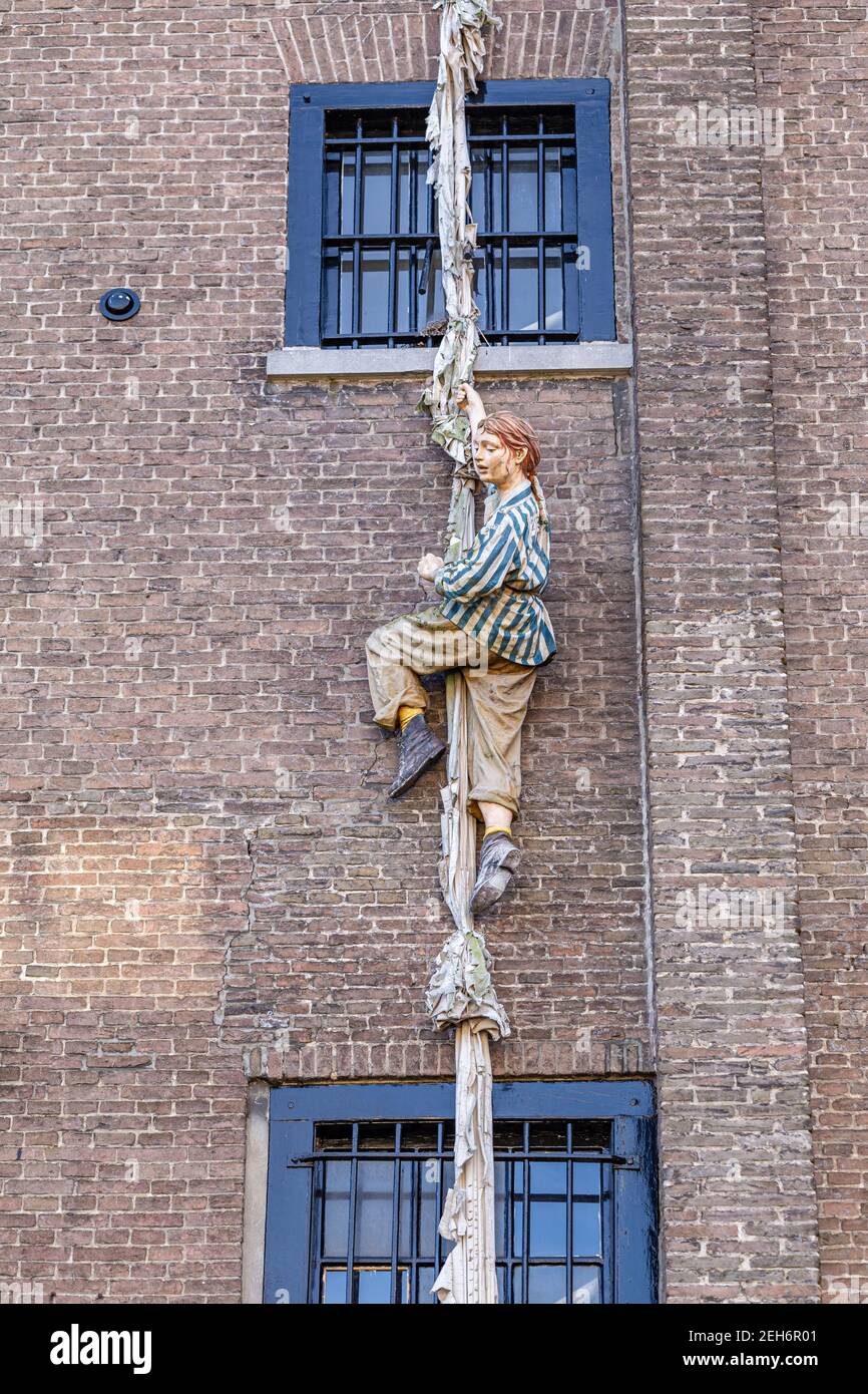 Woman climbing out window hi-res stock photography and images - Alamy
