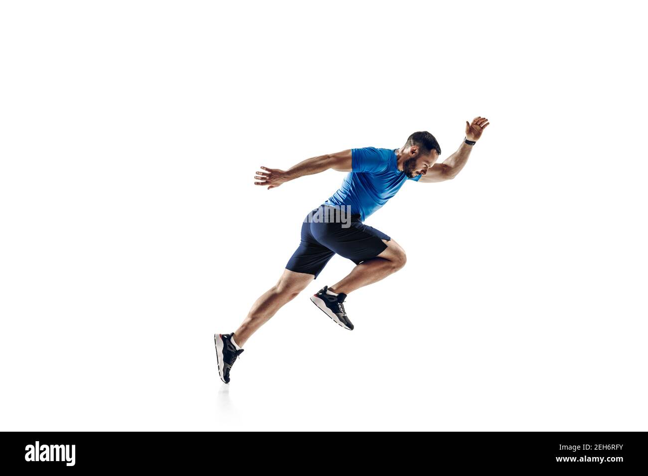 In air. Caucasian professional male athlete, runner training isolated ...