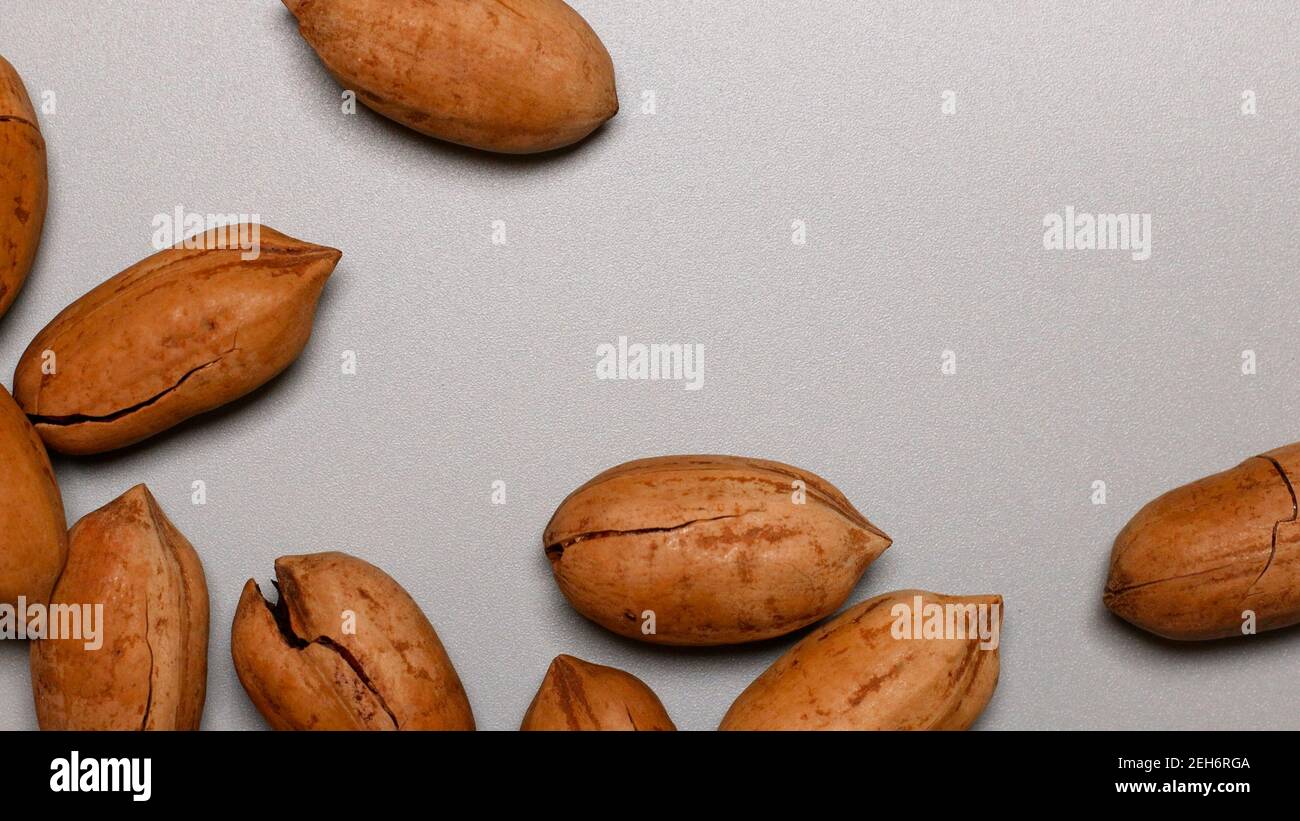 Assorted pecan nuts in shell on gray background with copy space Stock ...