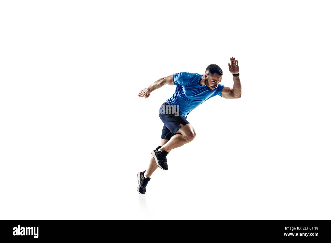 In air. Caucasian professional male athlete, runner training isolated ...