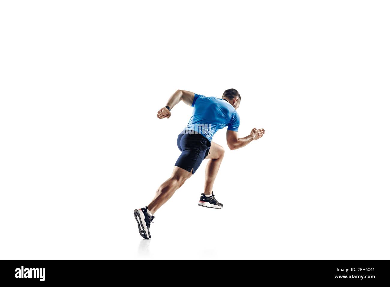 In jump. Caucasian professional male athlete, runner training isolated ...