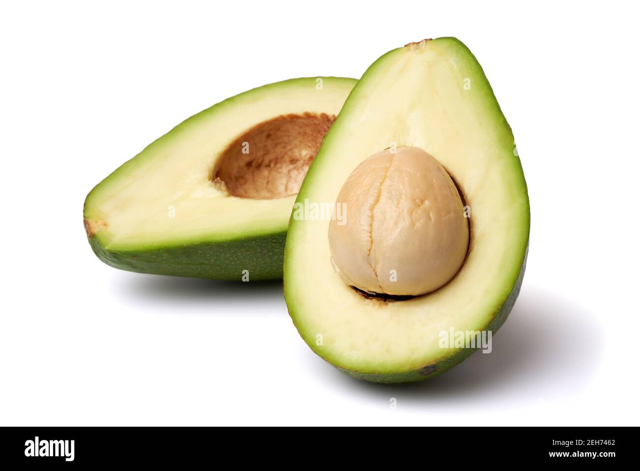 Halved avocado with seed isolated on a white background with clipping ...