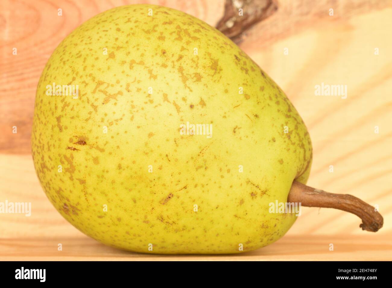 One whole and two halves of ripe organic tasty Lucas pear, on a white ...