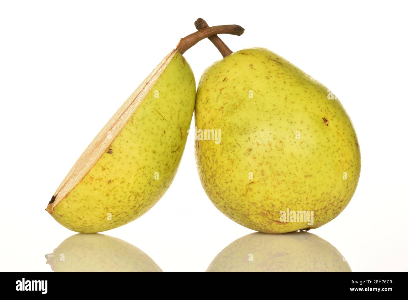 One whole and one half ripe organic tasty Lucas pears, close-up, on a ...