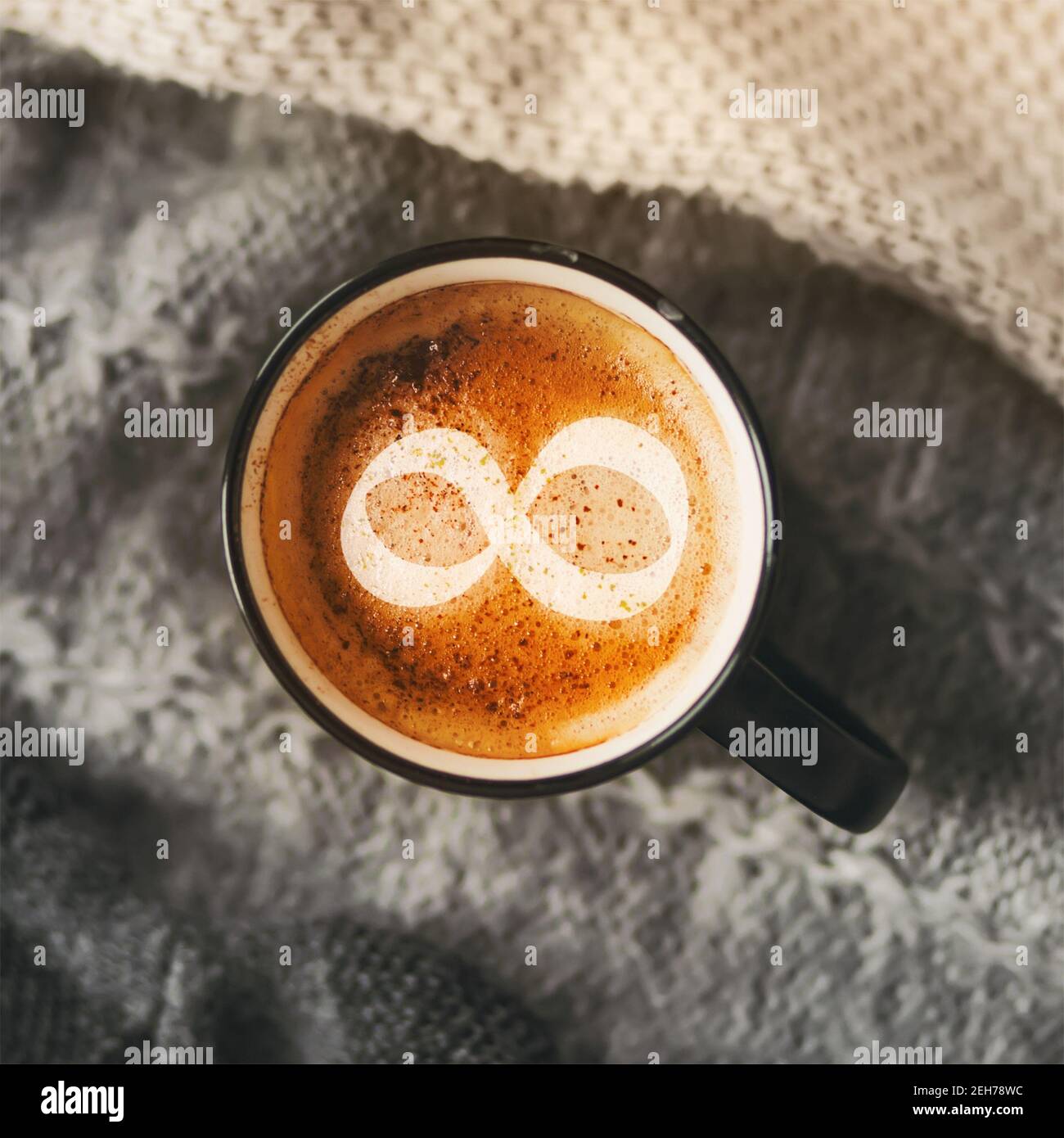 Top view of a black mug with a fragrant hot coffee with cinnamon, on ...