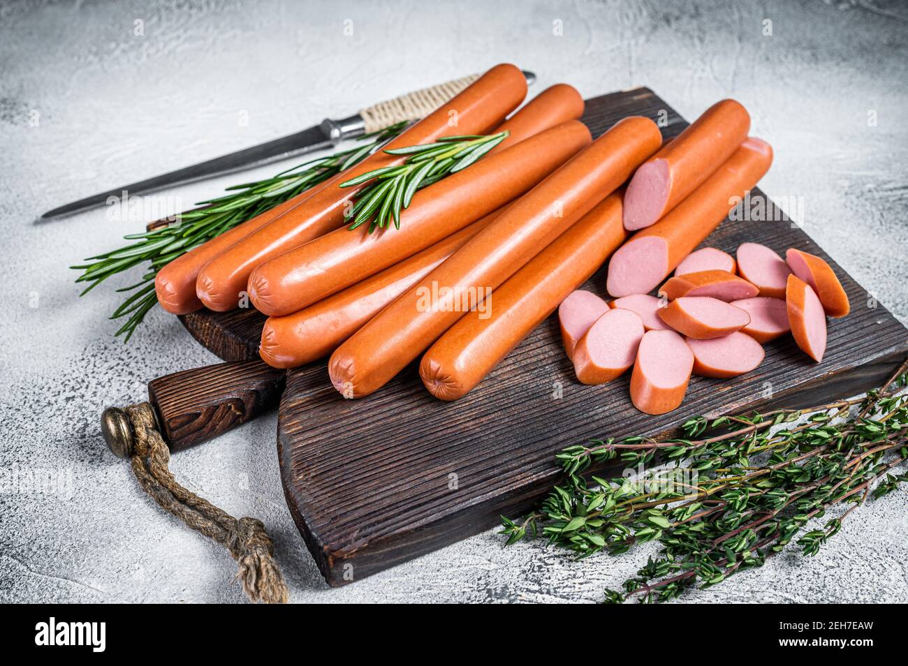 German raw Frankfurter sausages on a wooden board. White background ...