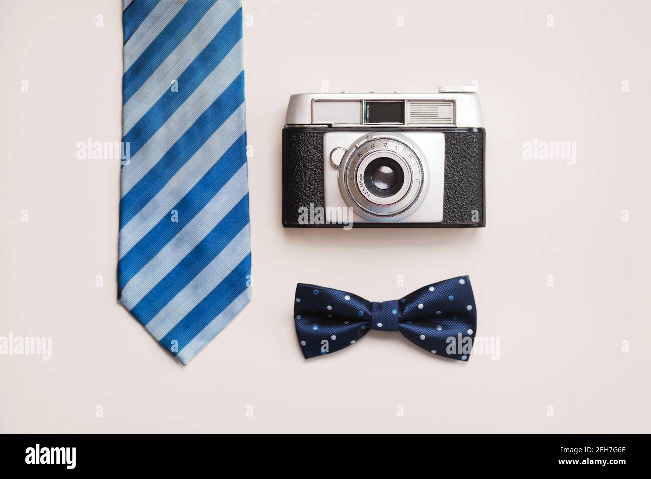 Happy Father's Day.Tie, bow tie and retro photo camera on a beige ...