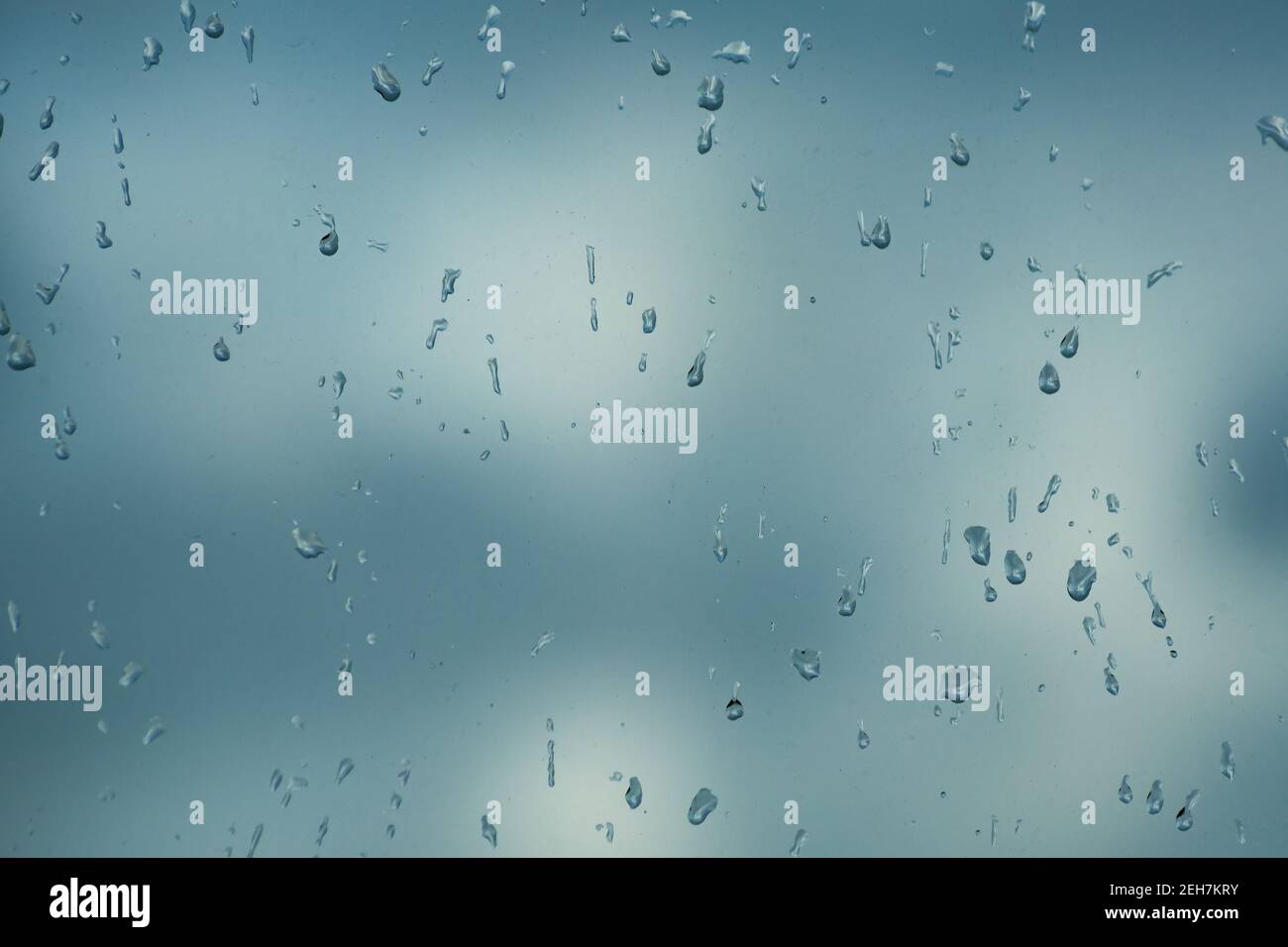 Rain drops on window with blured gray background. Seasonal background ...