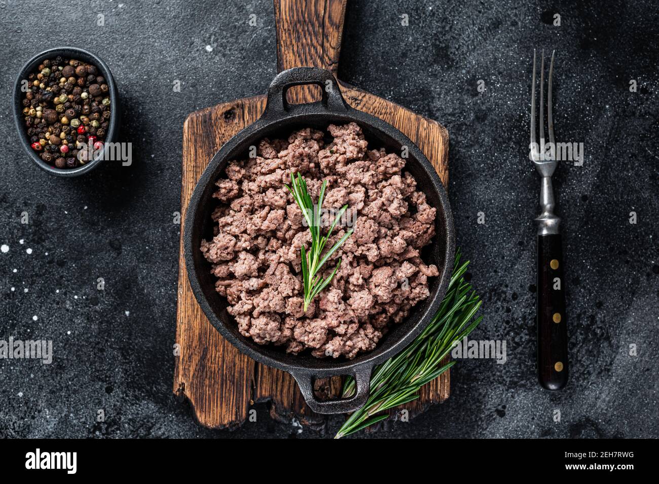 Fried mince beef meat in a pan for cooking pasta. Black background. Top ...