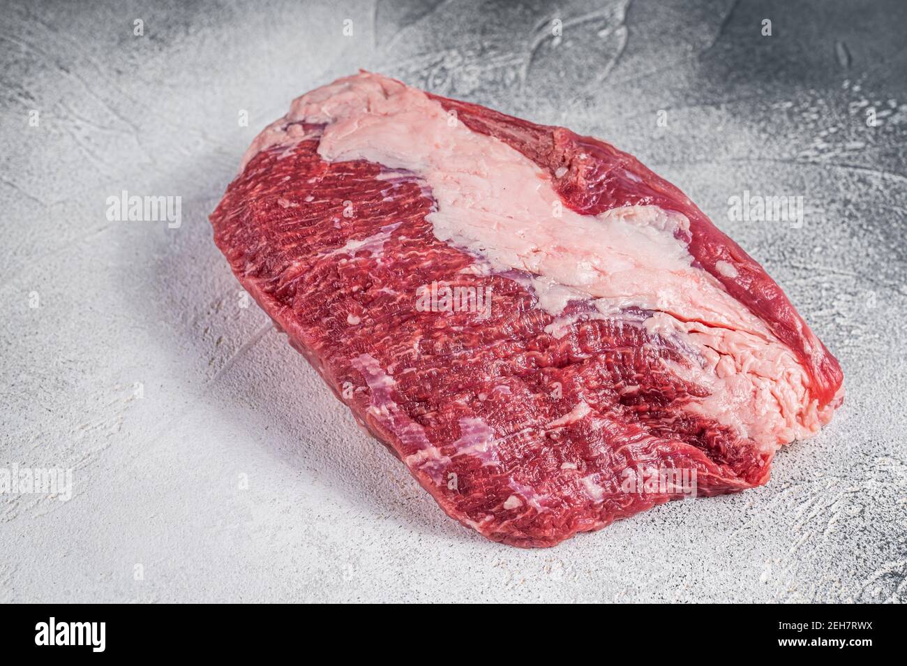Raw Round beef meat cut on a butcher table. White background. Top view ...