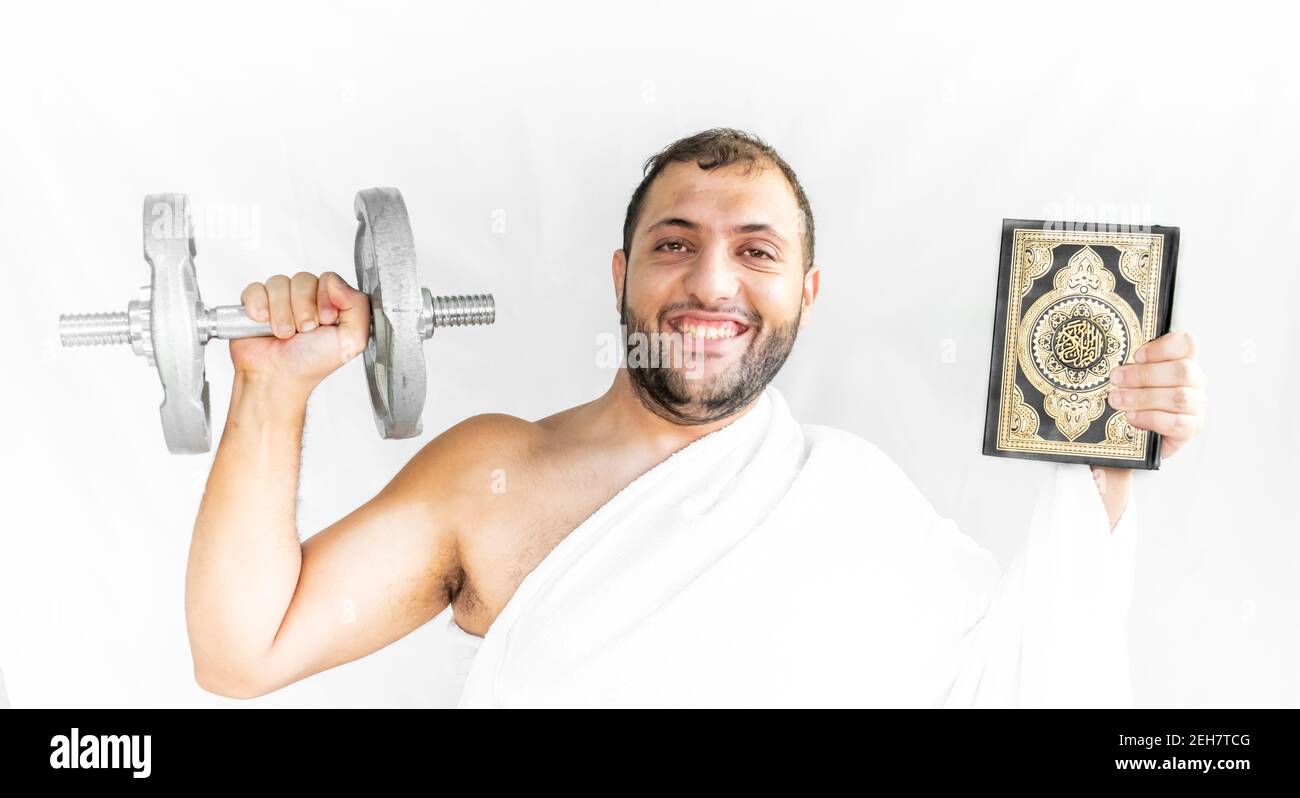 Muslim man showing the strength of the holy Quran Stock Photo - Alamy
