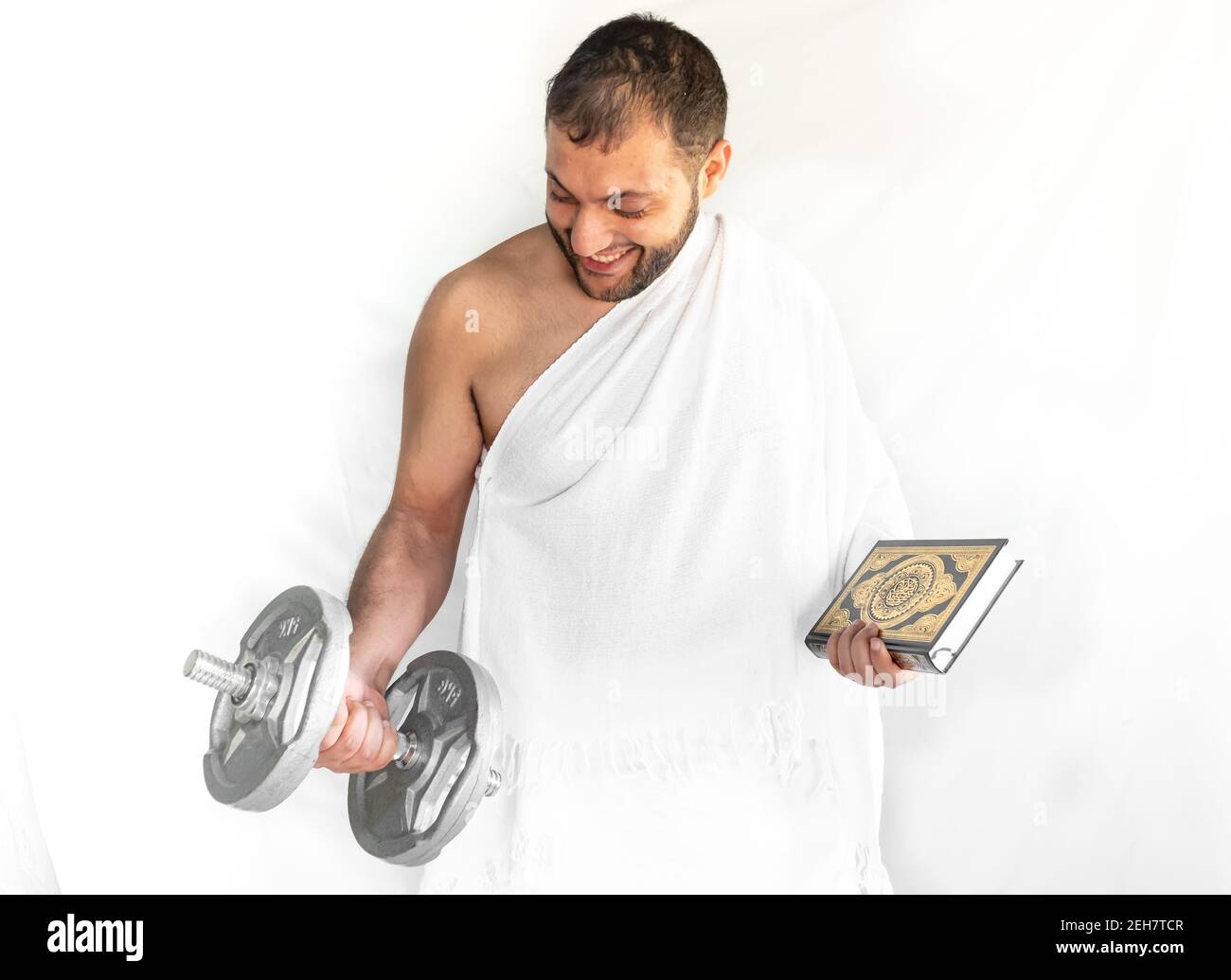 Muslim man showing the strength of the holy Quran Stock Photo - Alamy