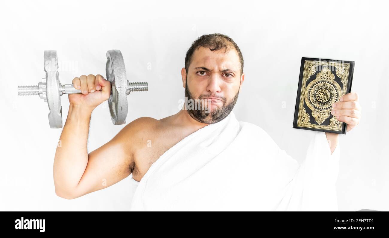 Muslim man showing the strength of the holy Quran Stock Photo - Alamy