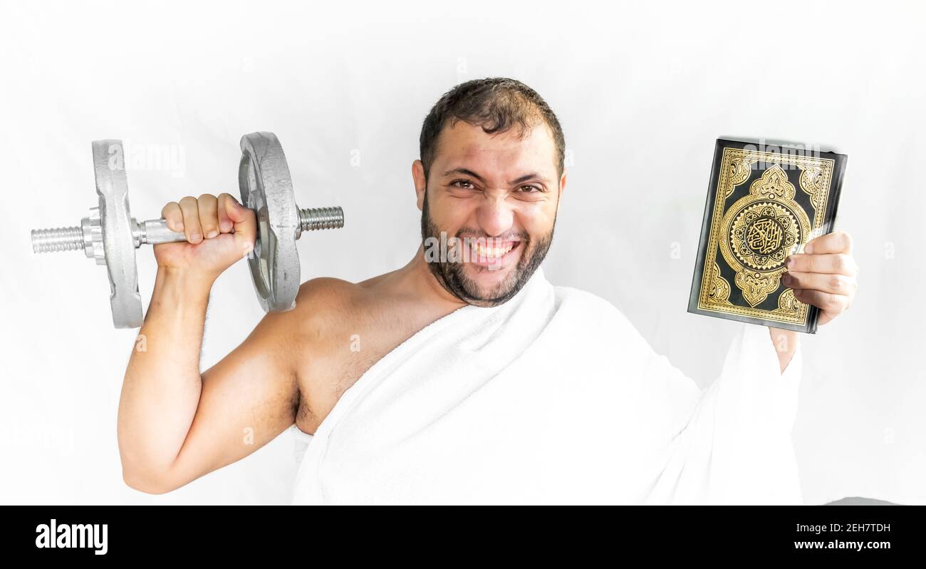 Muslim man showing the strength of the holy Quran Stock Photo - Alamy