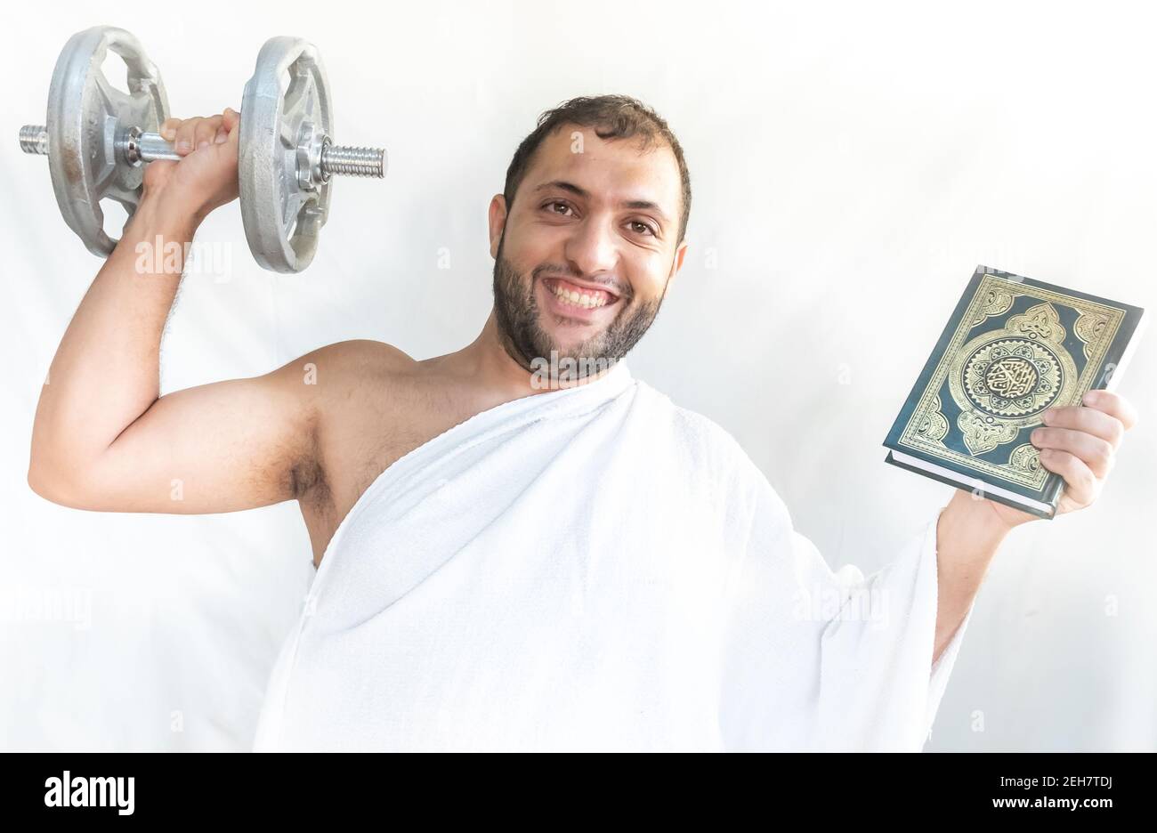 Muslim man showing the strength of the holy Quran Stock Photo - Alamy
