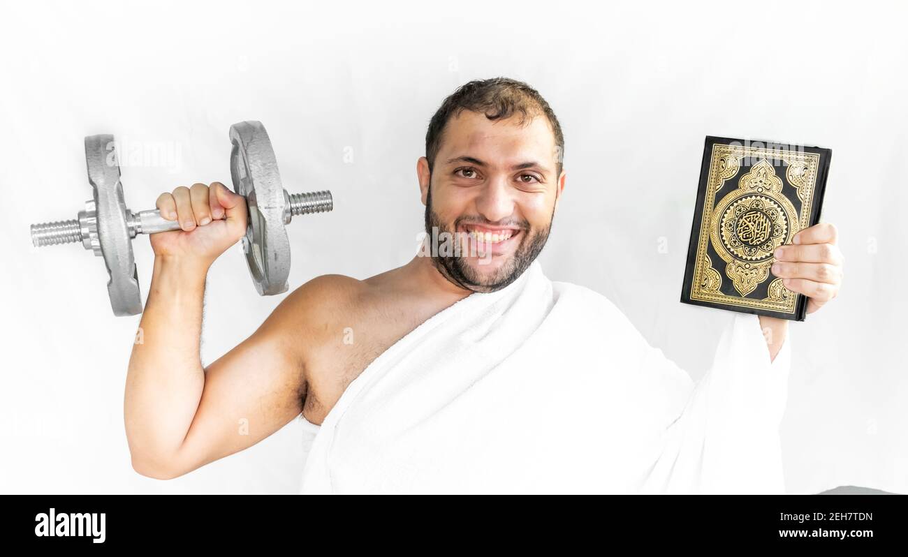 Muslim man showing the strength of the holy Quran Stock Photo - Alamy