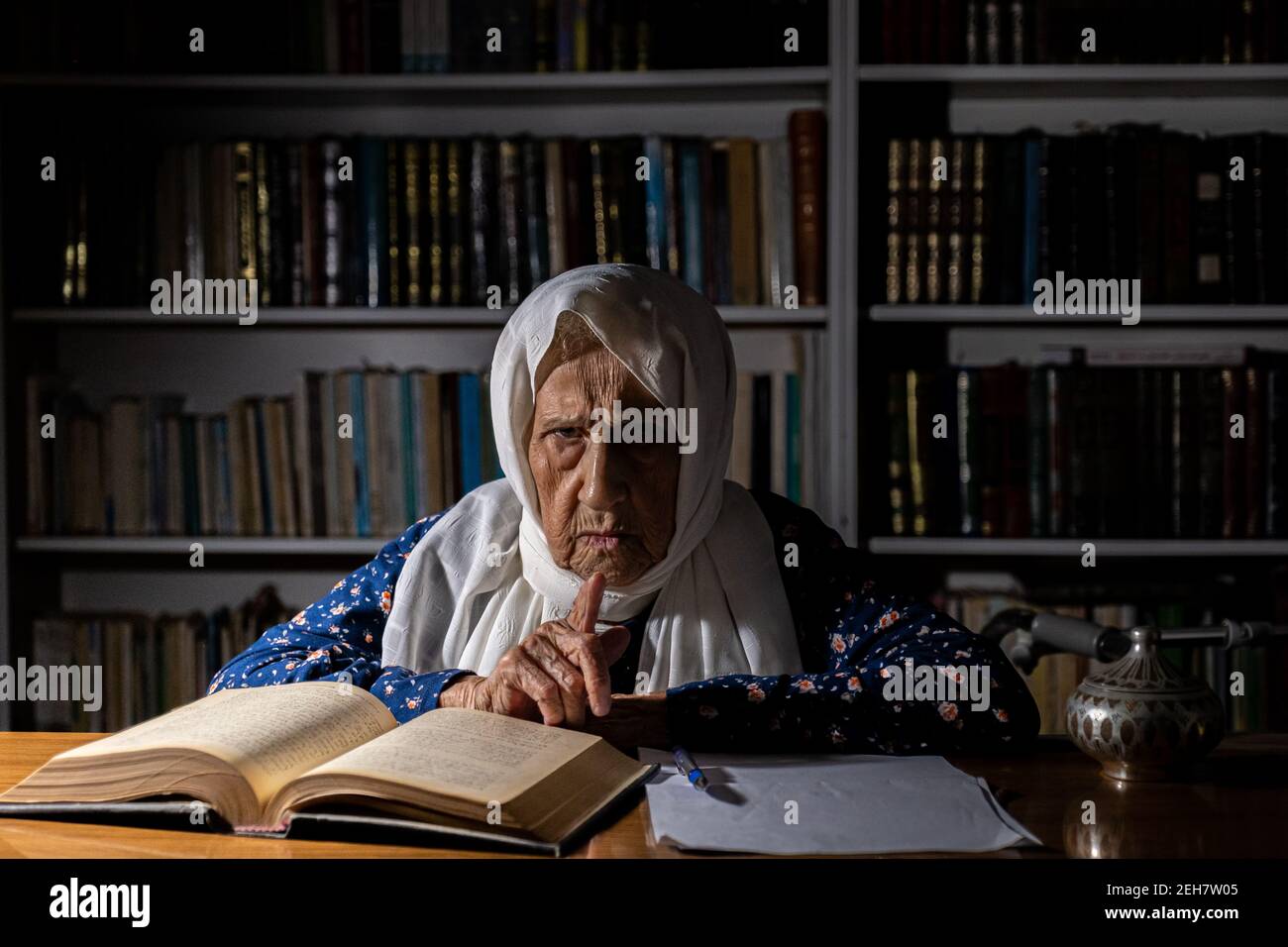 Old lady writing and reading some book at the morning light Stock Photo ...