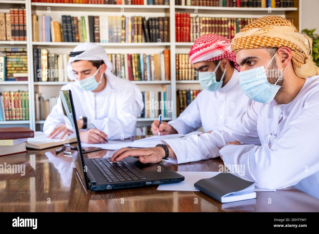 Arabic guys studying for exam together wearing protection masks Stock ...