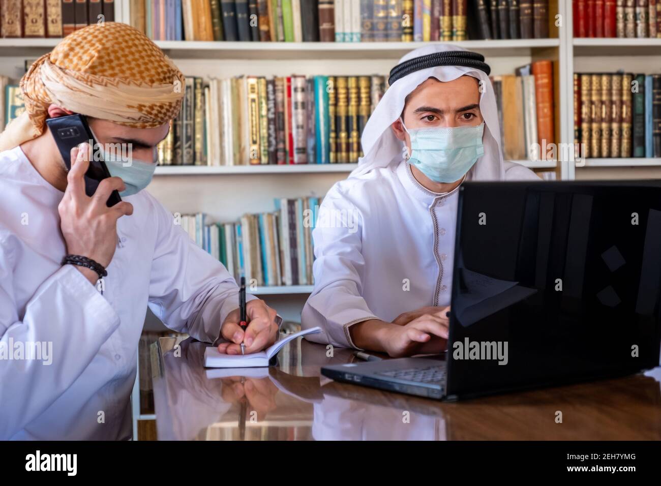 Arabic guys studying for exam together wearing protection masks Stock ...