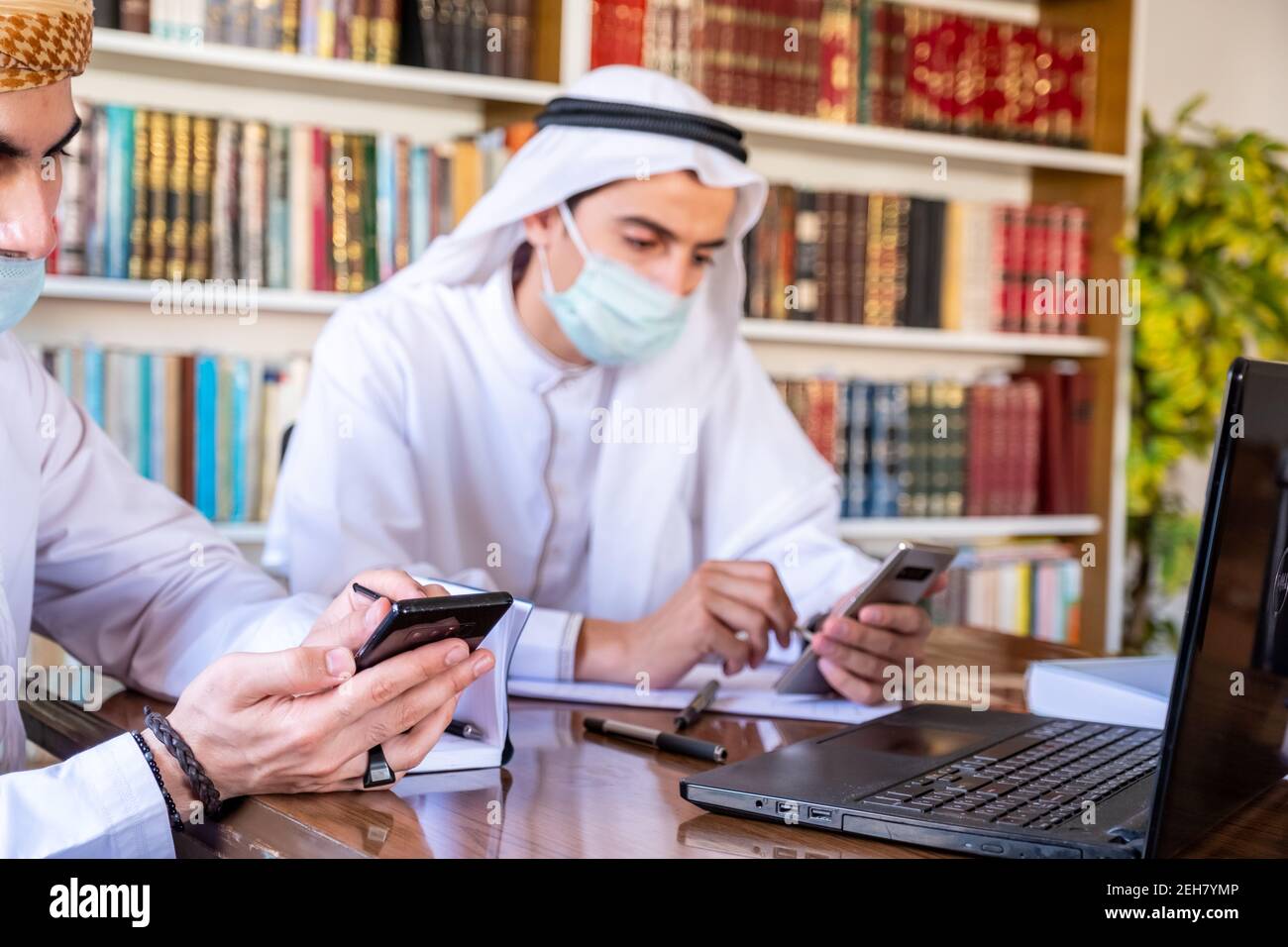 Arabic guys studying for exam together wearing protection masks Stock ...