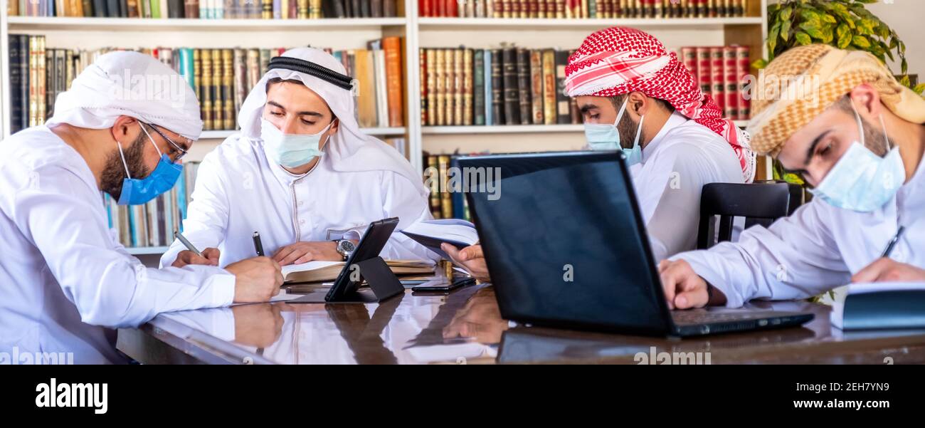 Arabic guys studying for exam together wearing protection masks Stock ...